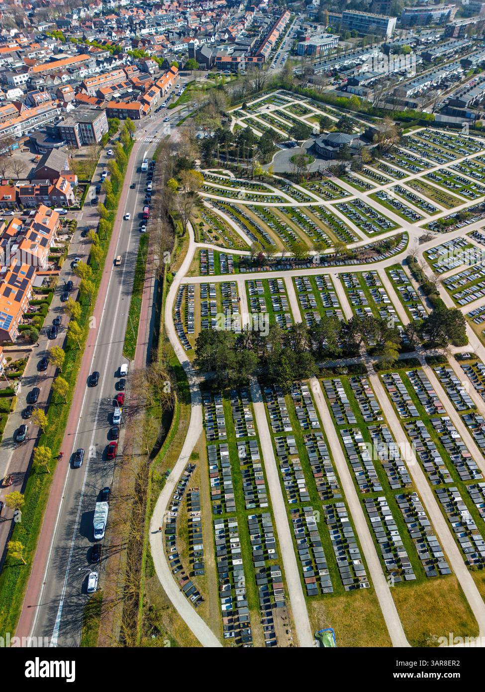 Aerial view of a cemetery with symmetrical rows of graves, a central ...