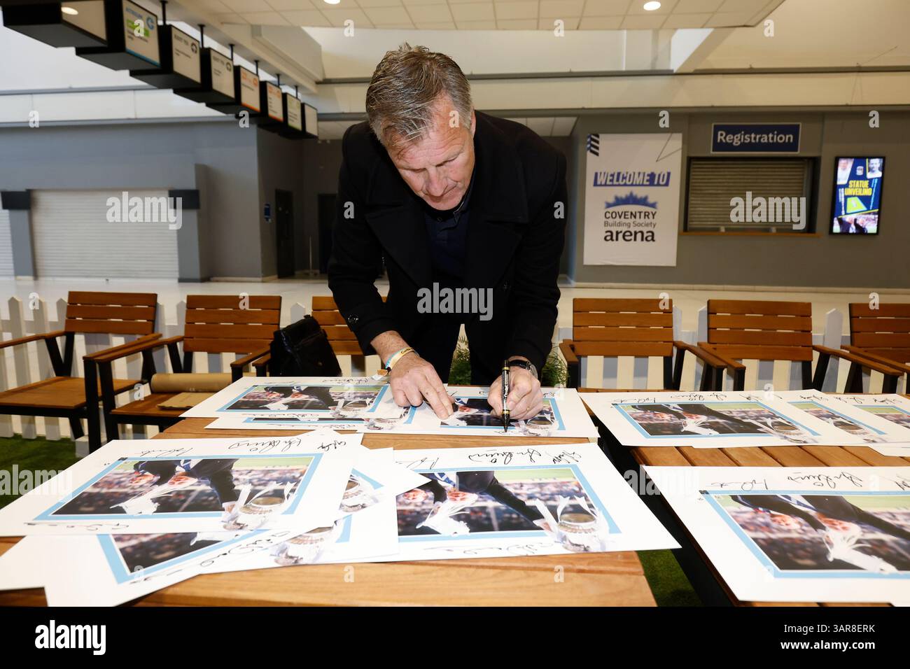 Former Coventry City player Keith Houchen signs prints during the ...
