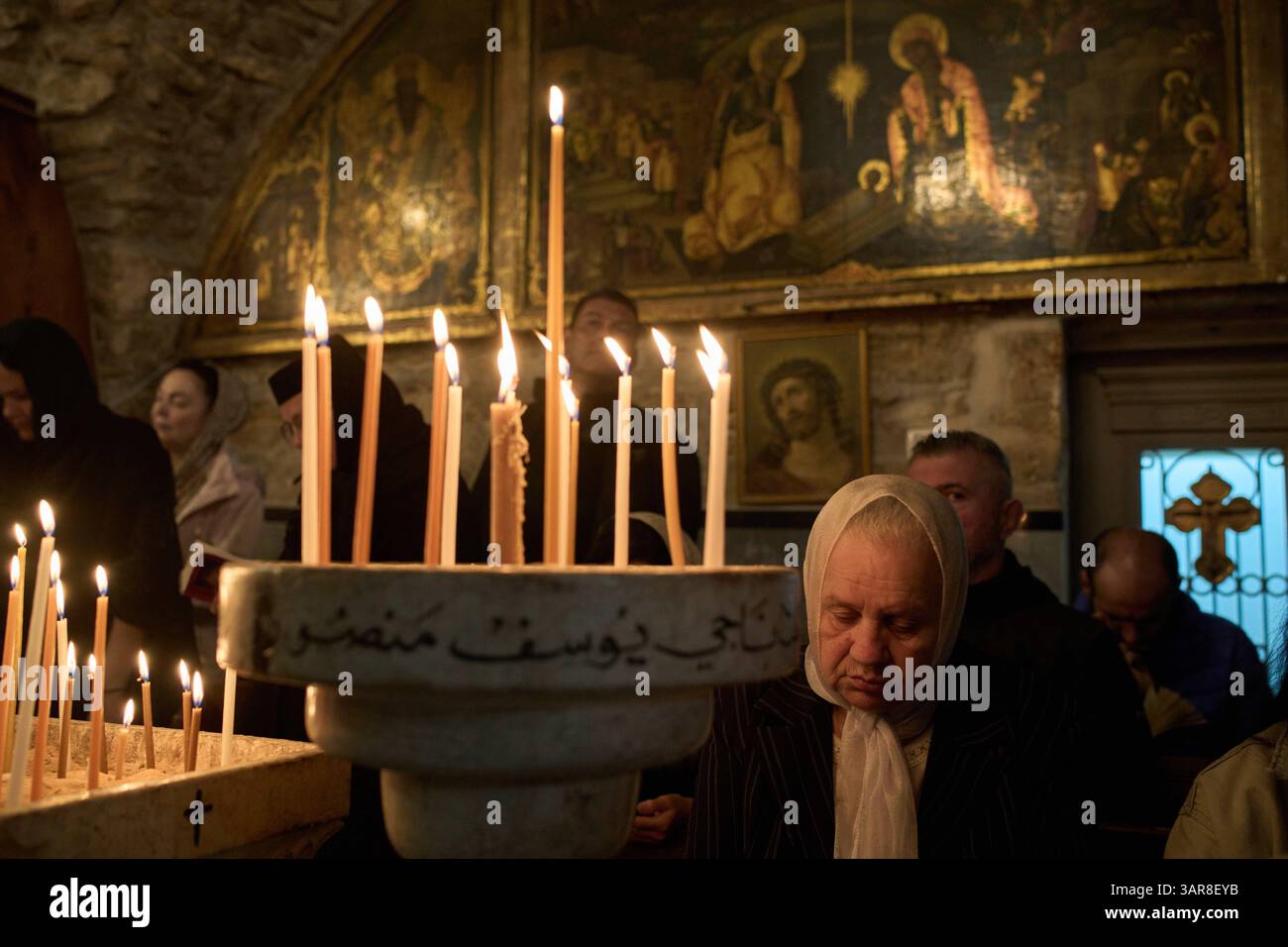 A Christian Orthodox attends a mass before the Washing of the Feet ...