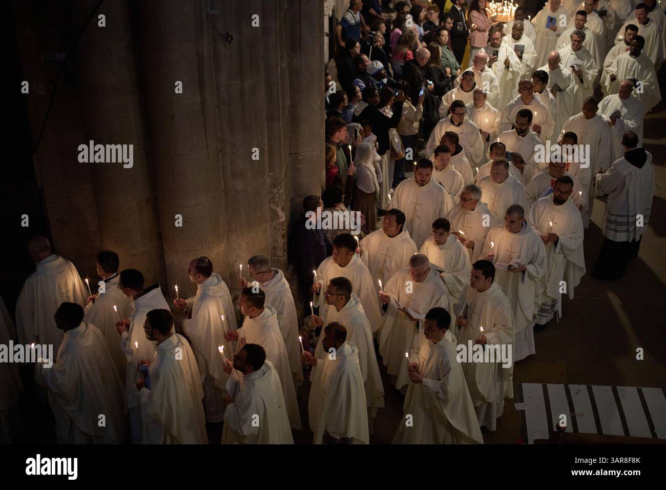 Catholic clergy hold candles as they walk during the Washing of the ...