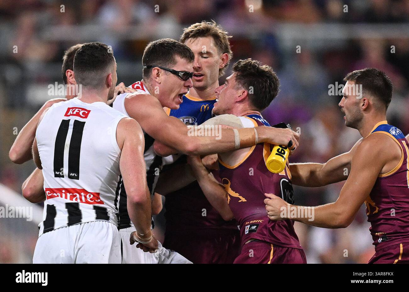 Mason Cox of the Magpies reacts with Noah Answerth of the Lions during ...