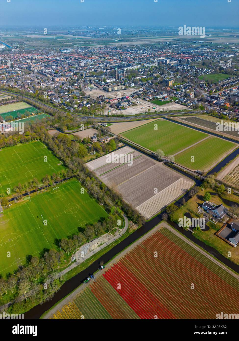 Aerial footage shows colorful tulip fields, greenhouses, and canals ...