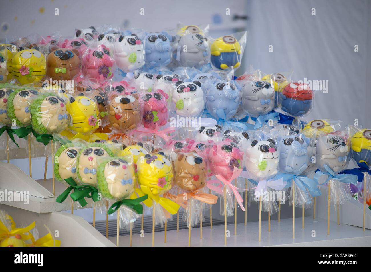 A vibrant display of animal-themed lollipops wrapped individually ...