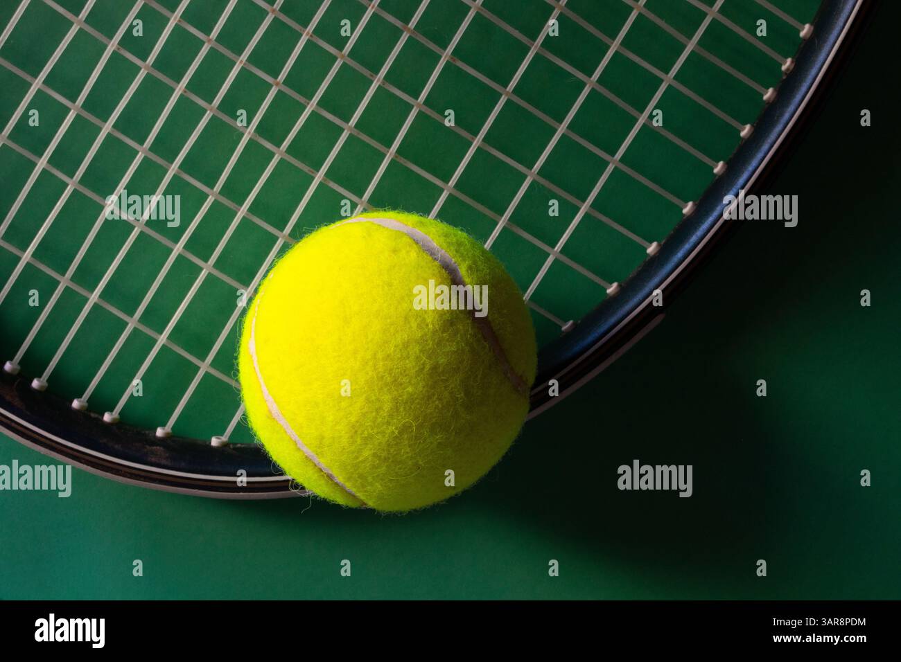 Tennis racket and balls on dark green background. Soft sidelight Stock ...
