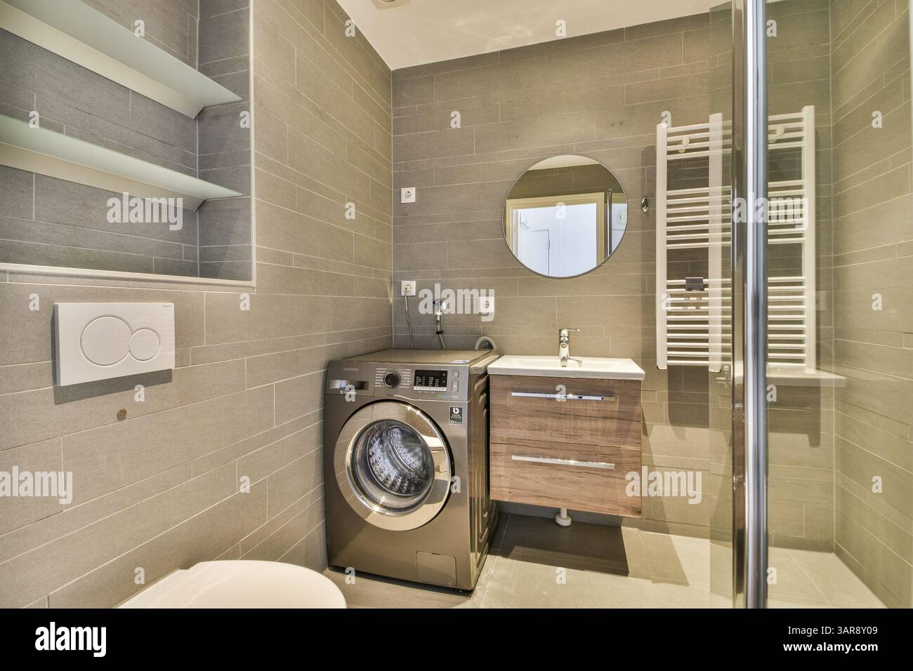 A sleek modern bathroom featuring a combination of grey tiles, a ...