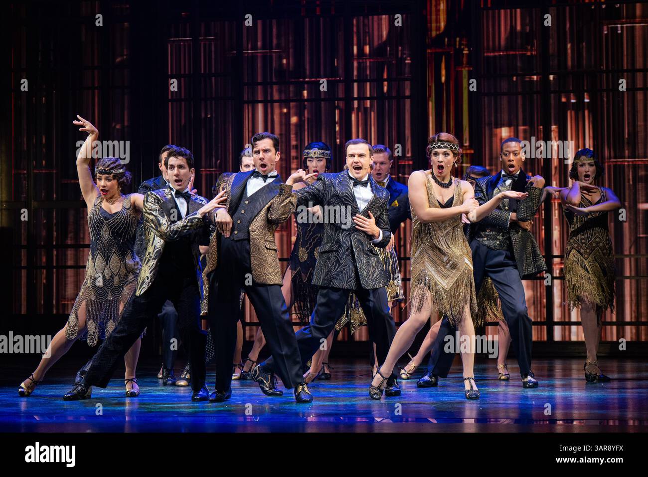 Cast members seen in full costume on stage performing scenes from The ...