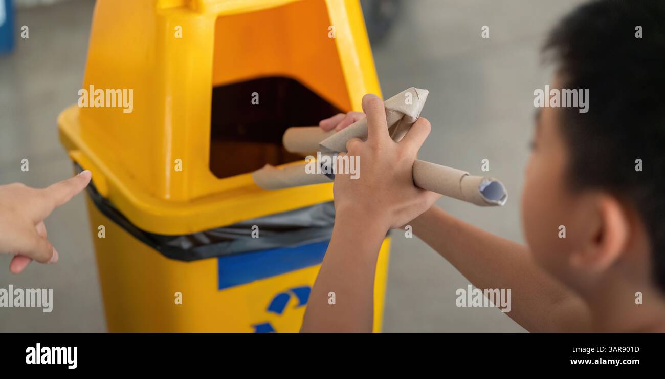 Waste Management and Family Collaboration. A child practices recycling ...