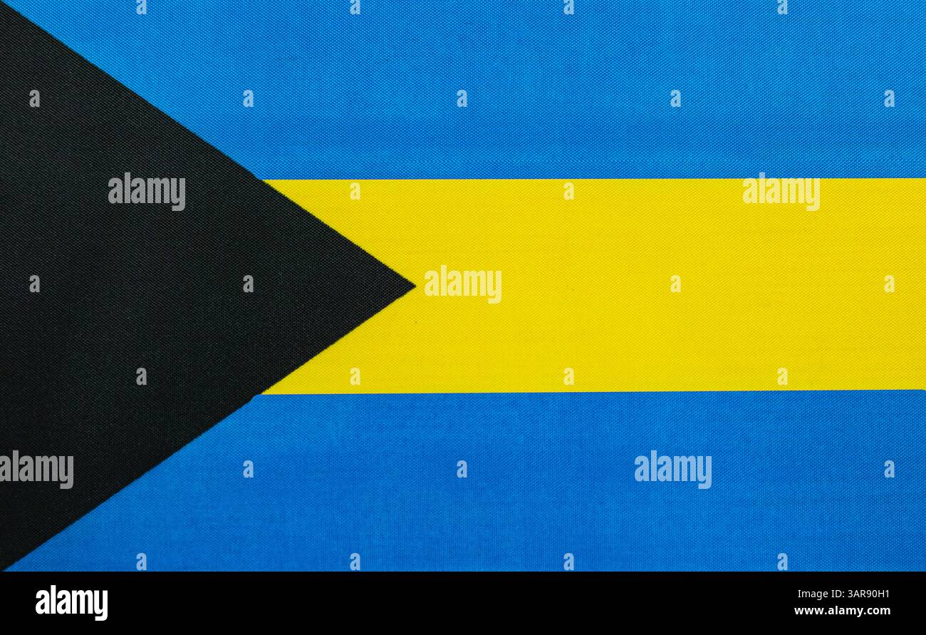 The flag of the Bahamas features bold colors of blue, yellow, and black ...