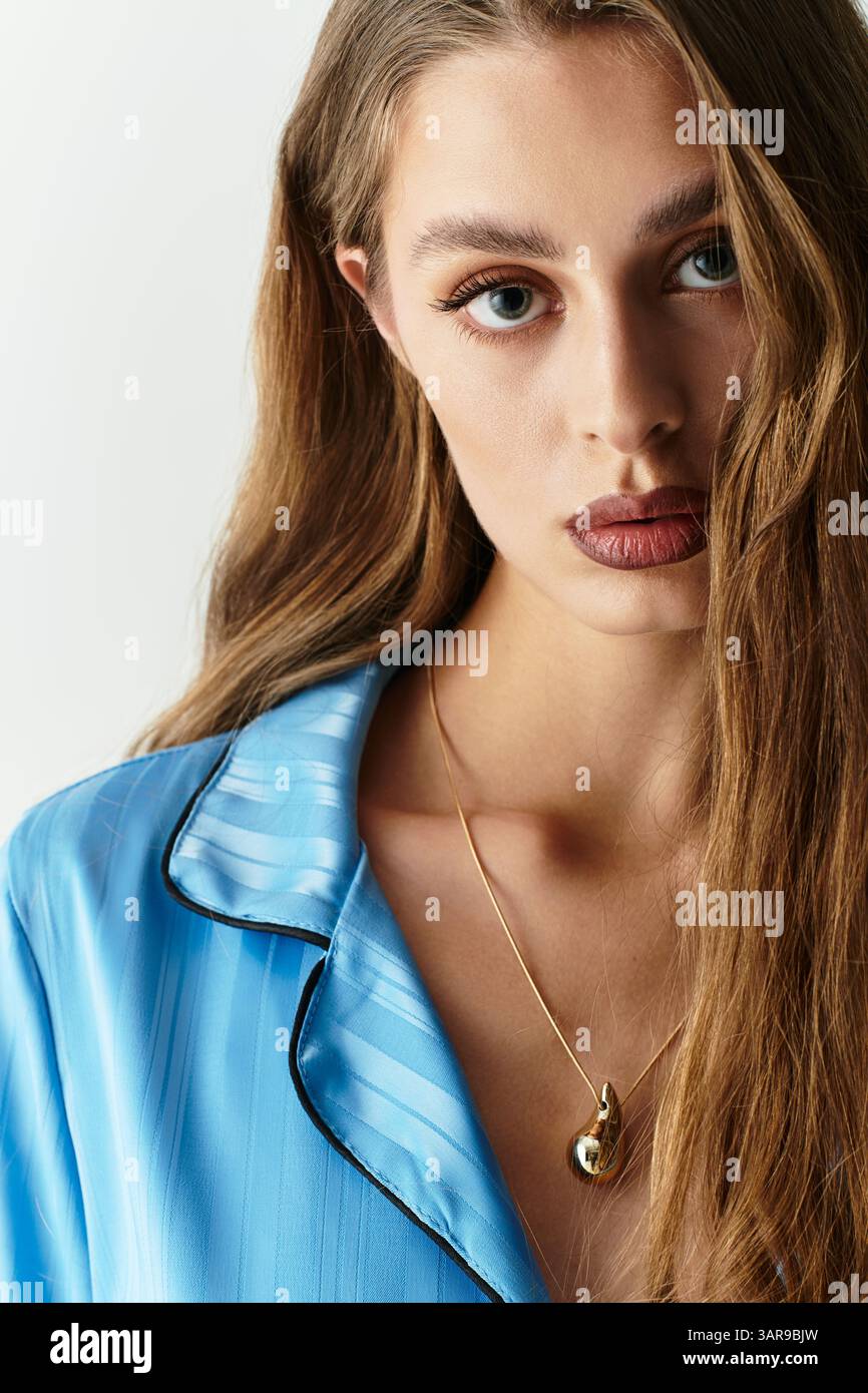 Elegant woman striking blue hi-res stock photography and images - Alamy