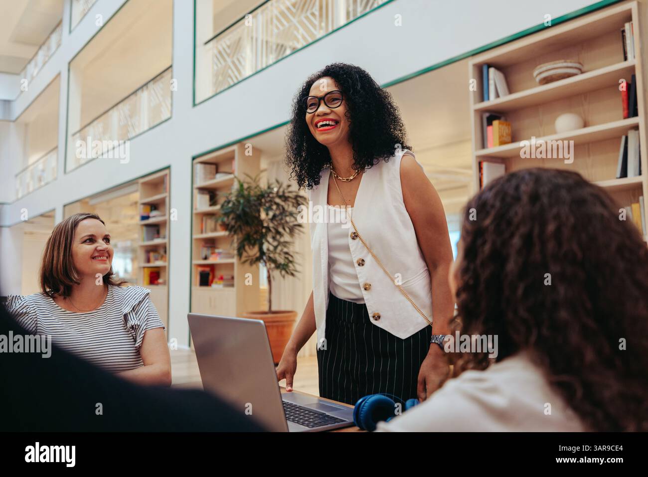 A diverse group of colleagues engaged in a collaborative meeting in a ...