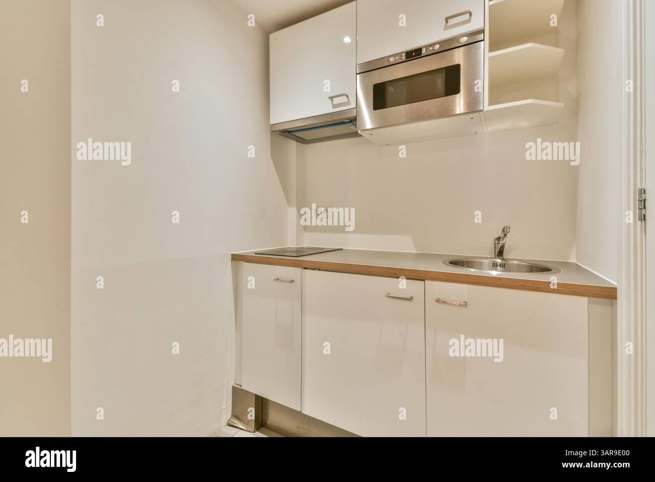 This image showcases a modern minimalist kitchen with sleek cabinetry ...