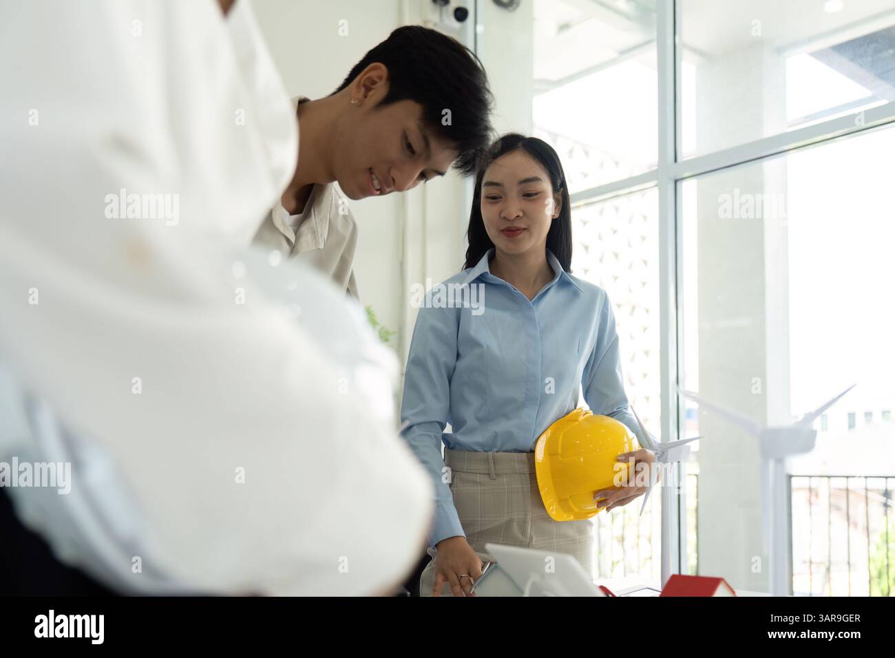 Teamwork and Innovation. A group of professionals assessing the impact ...