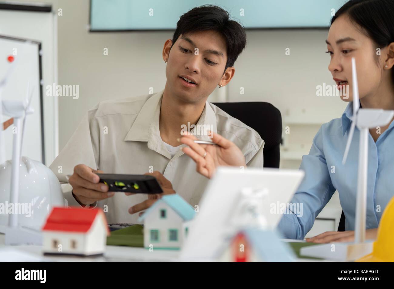 Collaboration in Sustainable Design. Young professionals engaging with digital tools to explore ...