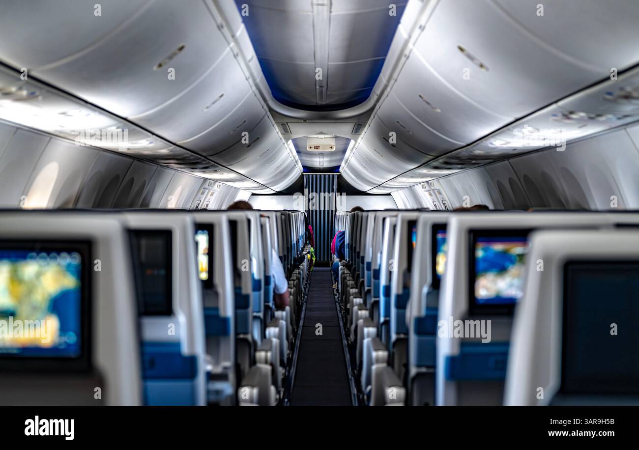 The economy class cabin of commercial narrow-body airliner during ...