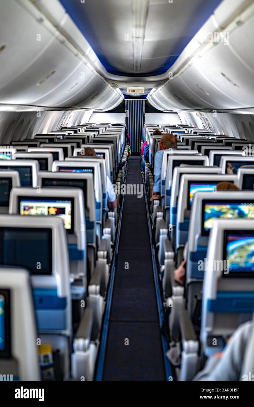 The economy class cabin of commercial narrow-body airliner during ...