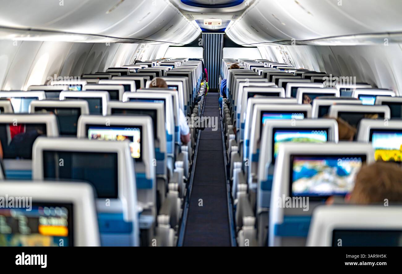 The economy class cabin of commercial narrow-body airliner during ...