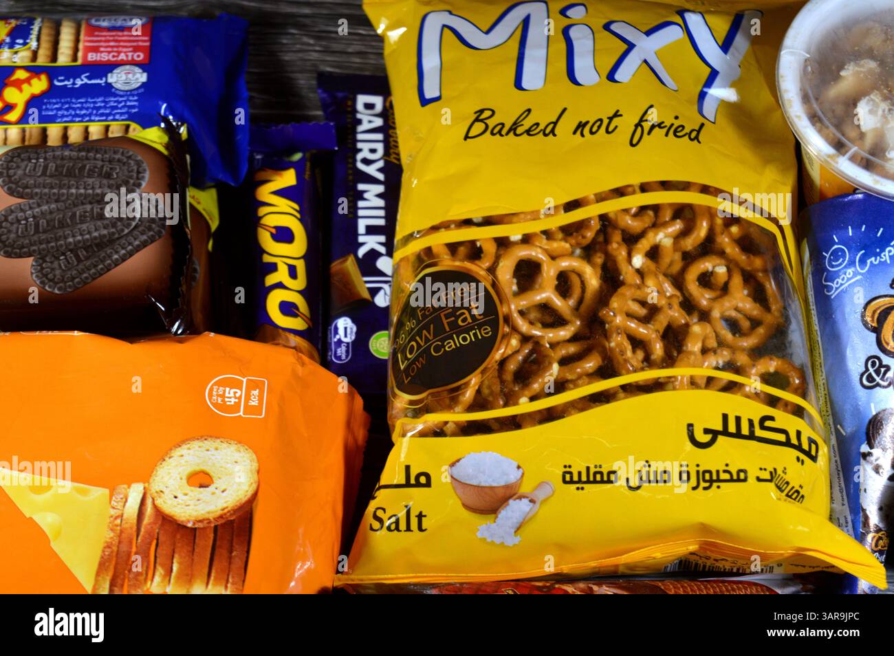Cairo, Egypt, March 15 2025: snacks and sweets of bake rolz baked wheats, Mixy pretzels, Friday ...