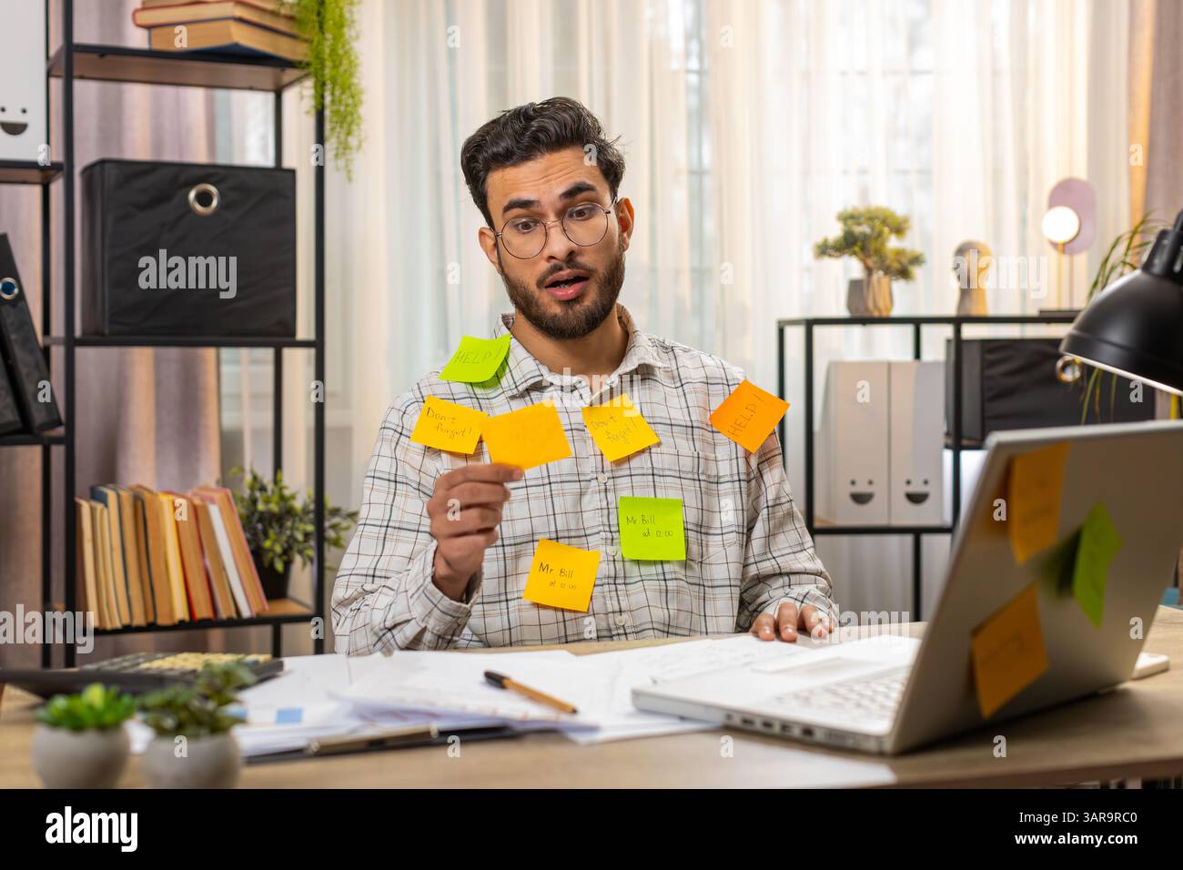 Tired exhausted fatigue young Indian businessman office employee ...