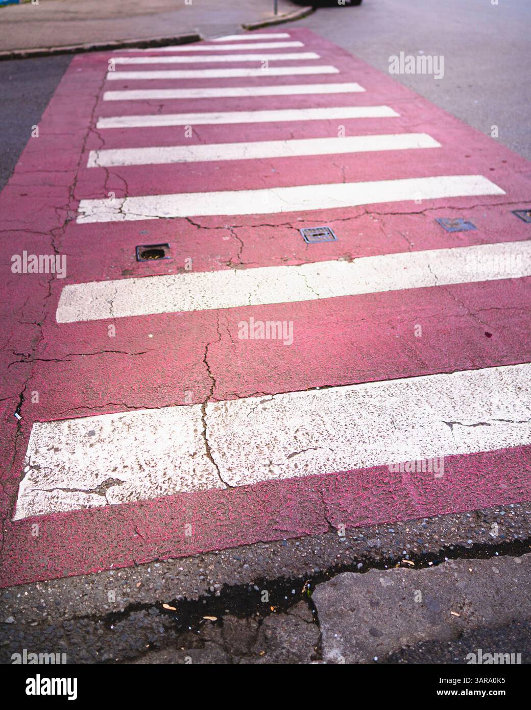 pedestrian crossing red asphalt white lines weathered cracked asphalt ...