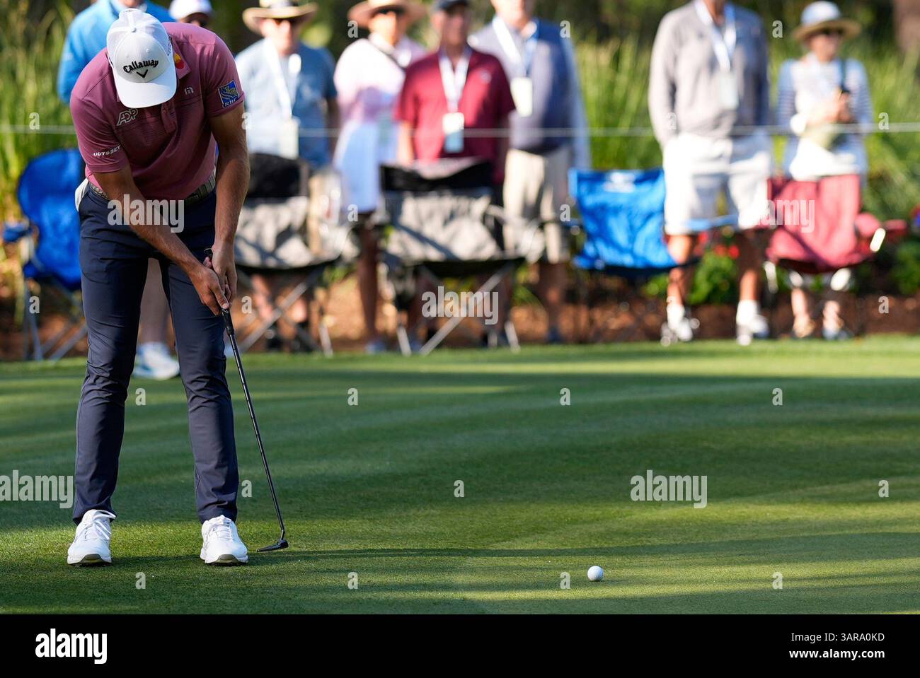 Sam Burnes watches his putt on the first hole during the first round of ...