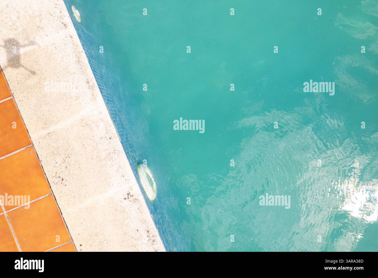 drone shot of a clear blue swimming pool from above top-down view with ...