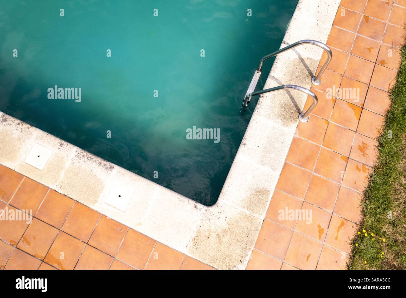 drone shot of a clear blue swimming pool from above top-down view with ...
