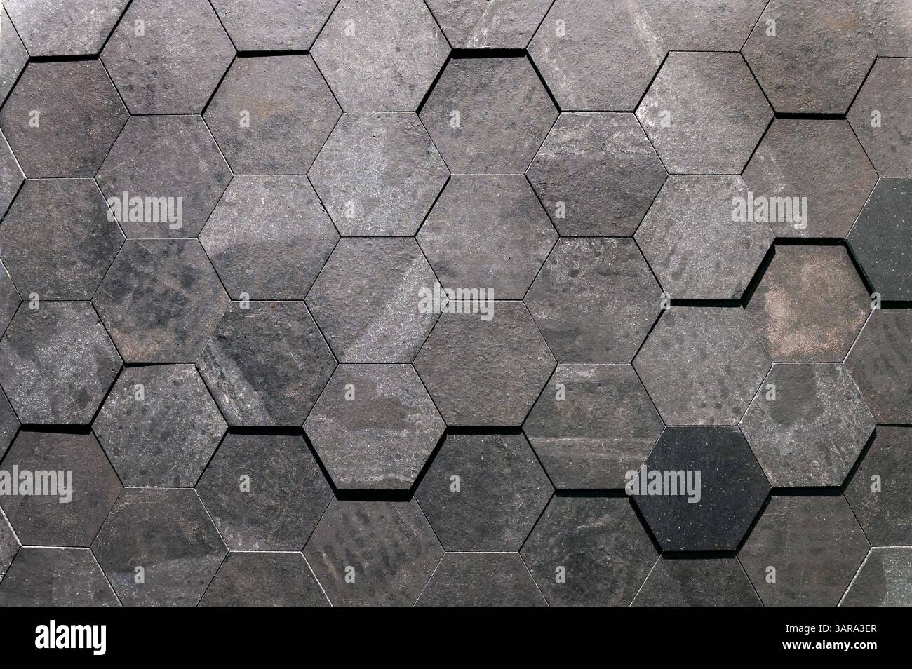 Dark gray hexagonal tiles forming a textured background, ideal for ...