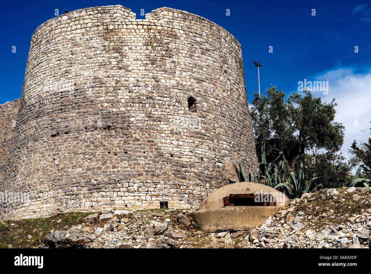 A historic stone tower with a circular structure, surrounded by ...
