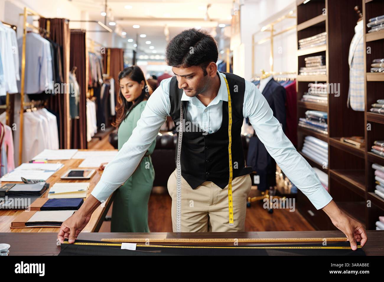 two Indian working in Taylor shop design Stock Photo - Alamy