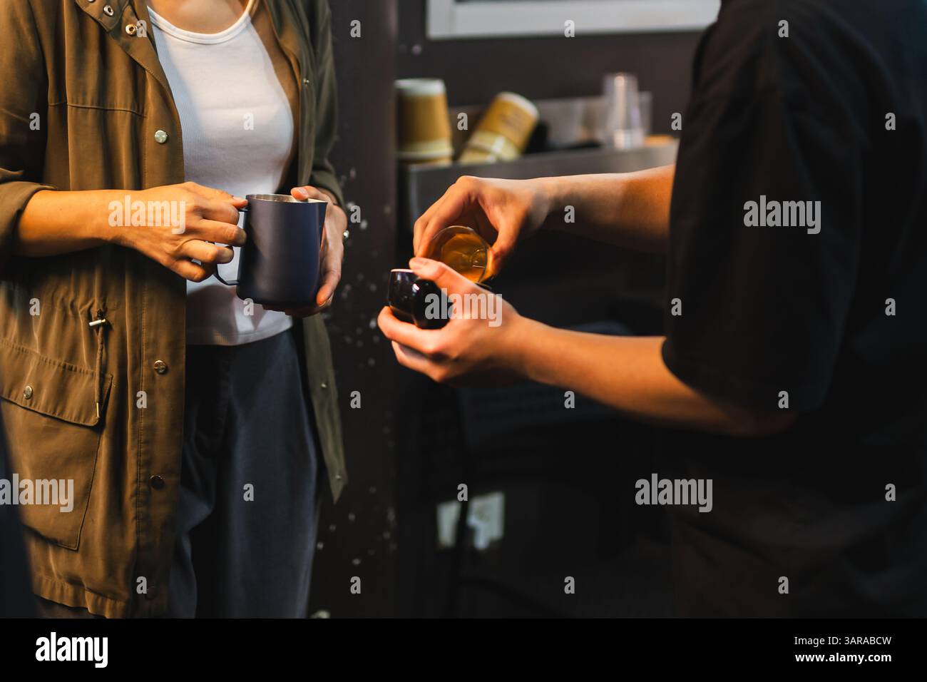 Barista coaching teaching woman to brew coffee in cafe Stock Photo - Alamy