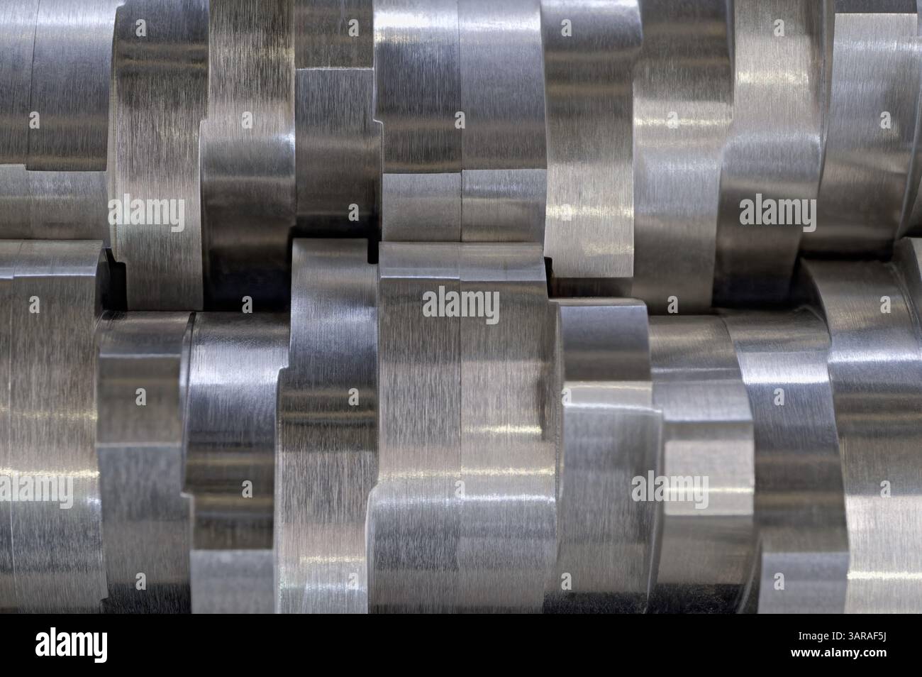 Toothed steel shaft of industrial plastic waste shredder, close up shot ...