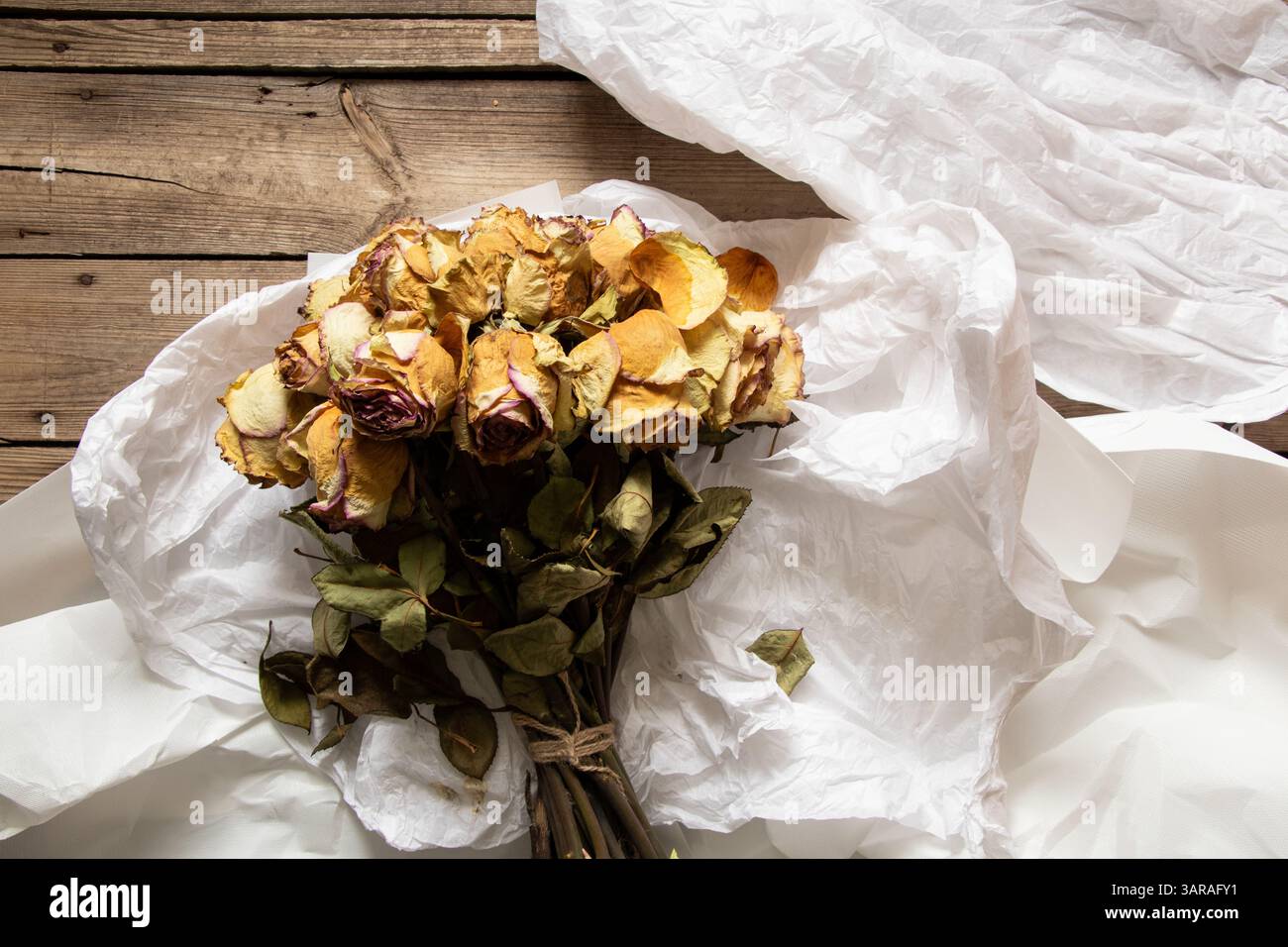Large bouquet with roses and white wrapping on the table in ...