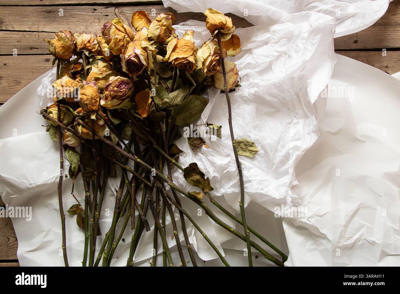 Large bouquet with roses and white wrapping on the table in ...