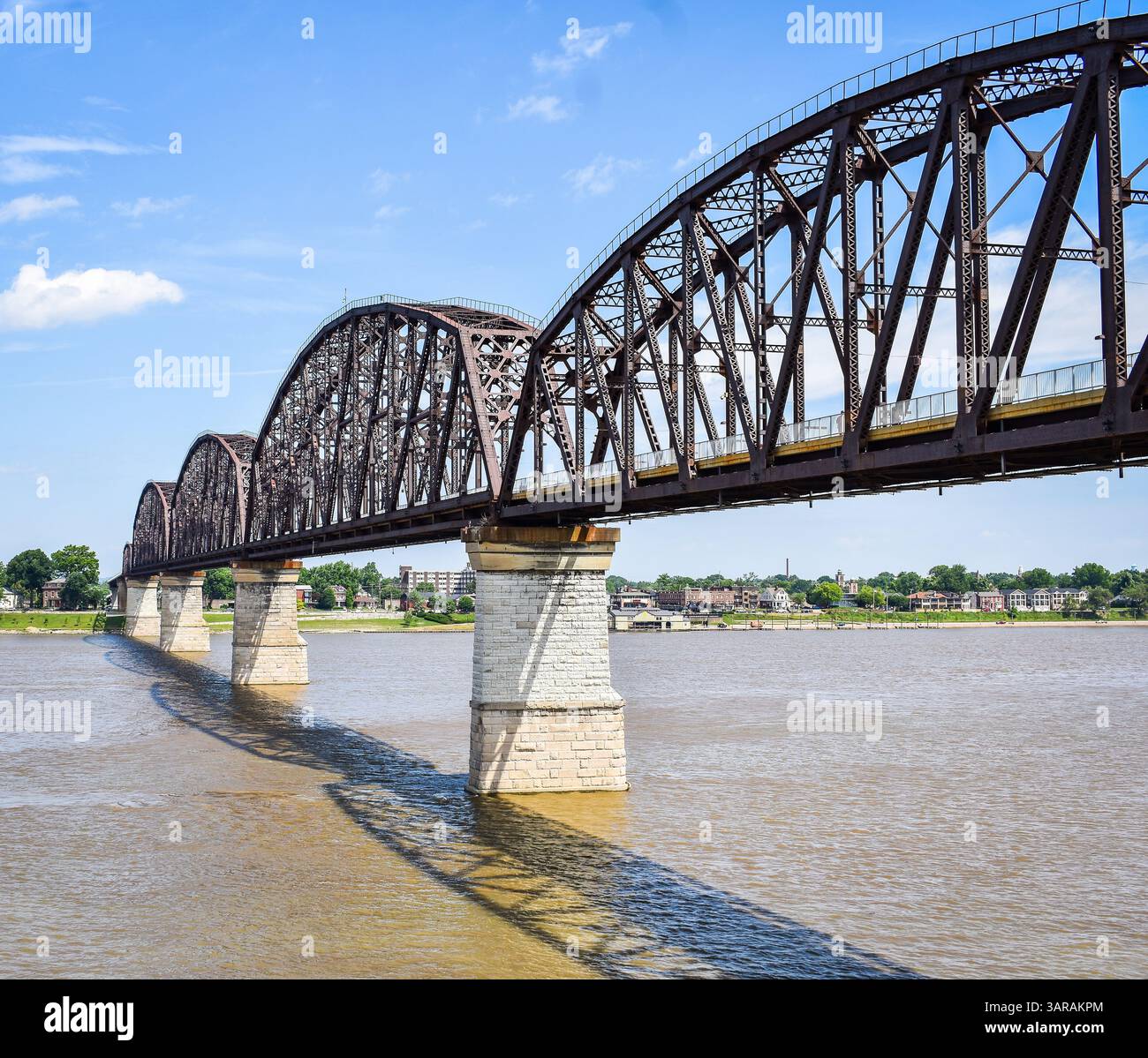 Six span former railroad truss bridge on stone pilings over river Stock ...