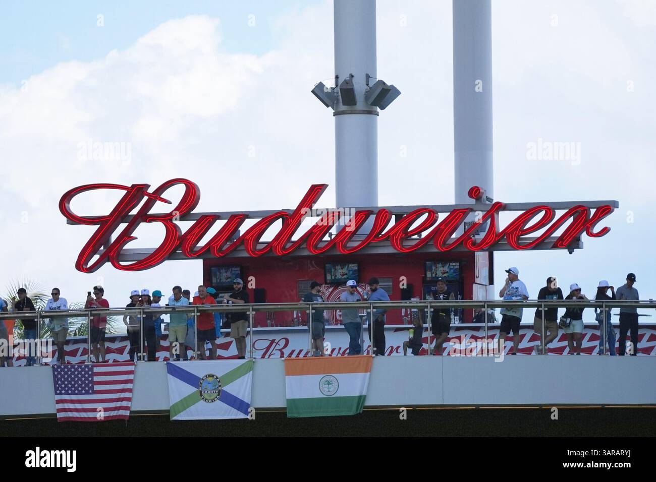 Fans stand under the Budweiser sign before the baseball game between ...