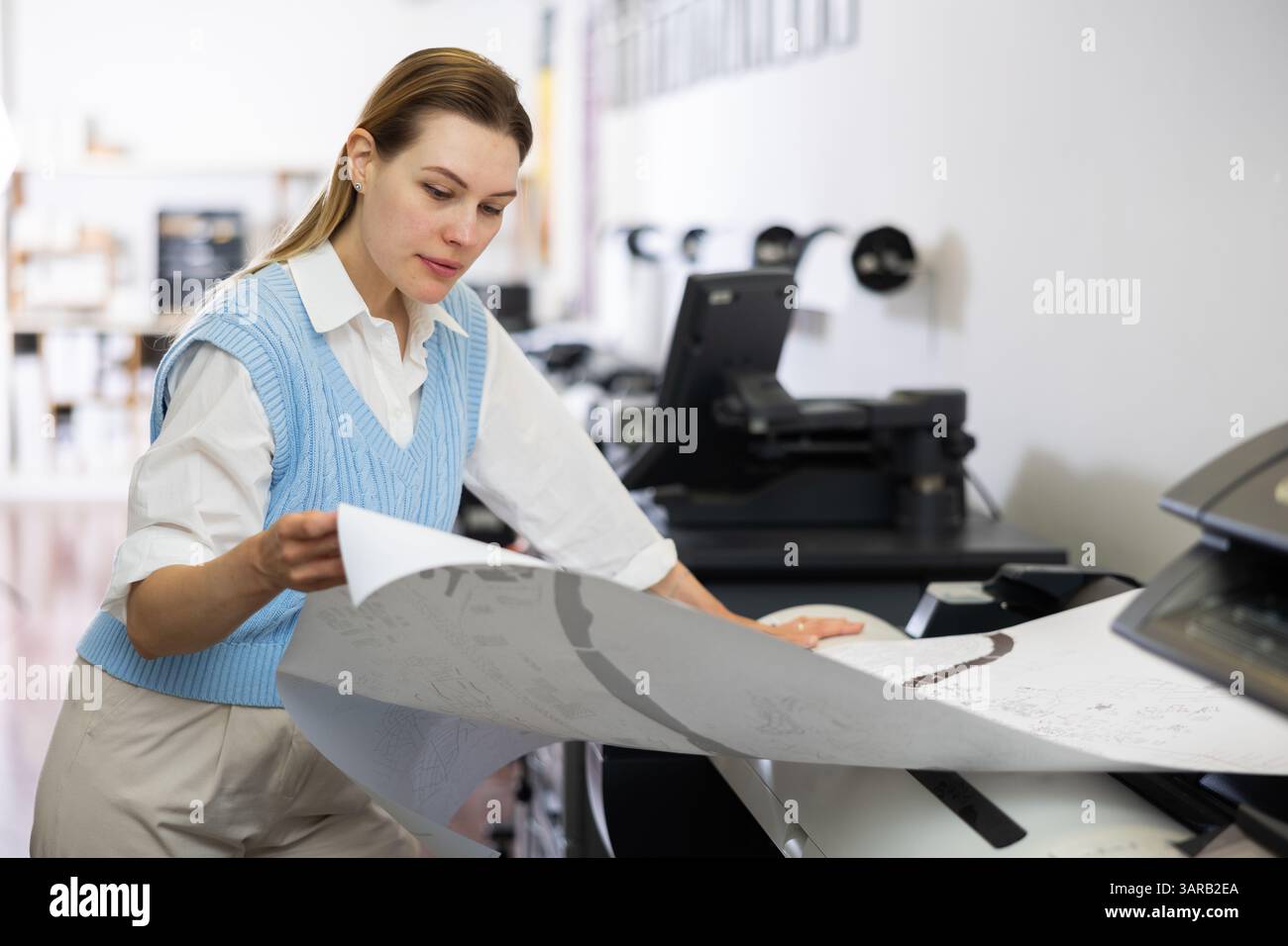 Woman working in printing office, using printer Stock Photo - Alamy