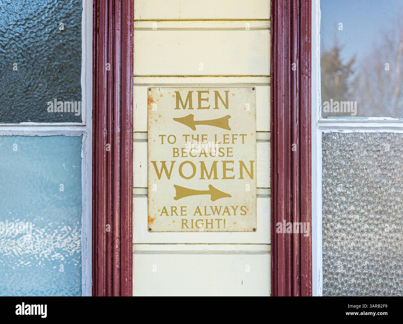 Humorous old fashioned quirky sign pointing to Ladies and gents toilets ...