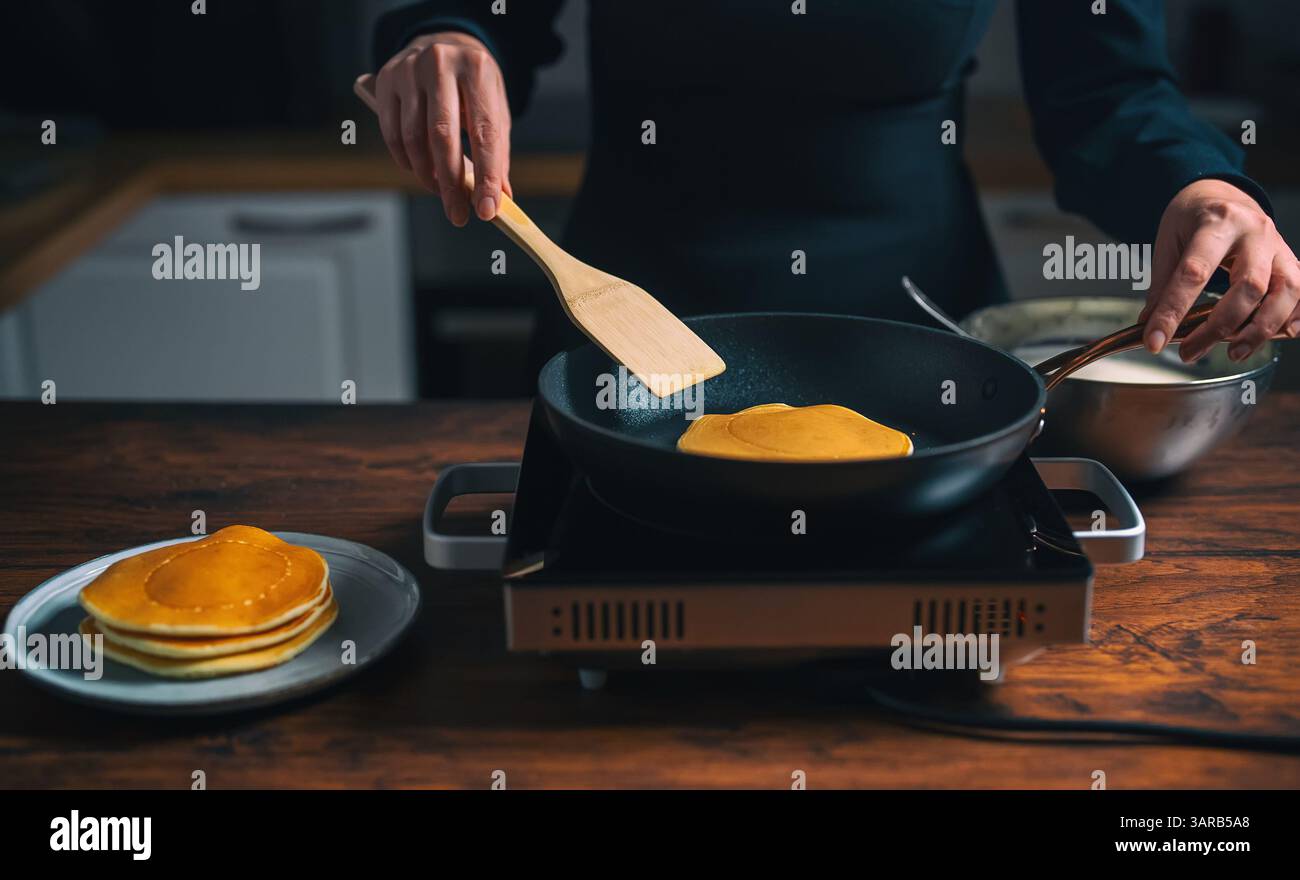 Spatula flipping pancakes in pan hi-res stock photography and images ...