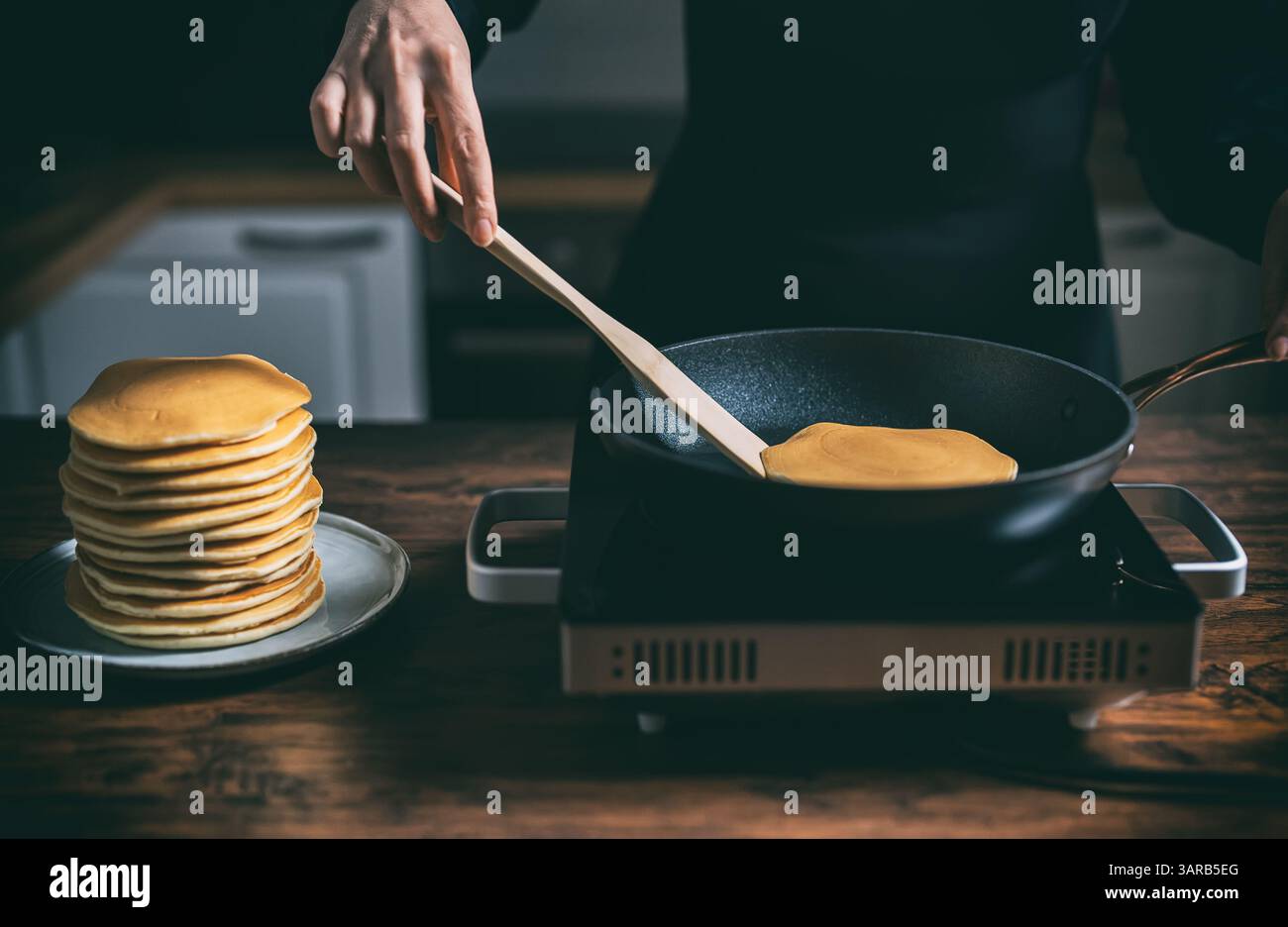 Woman flipping pancake in hi-res stock photography and images - Alamy