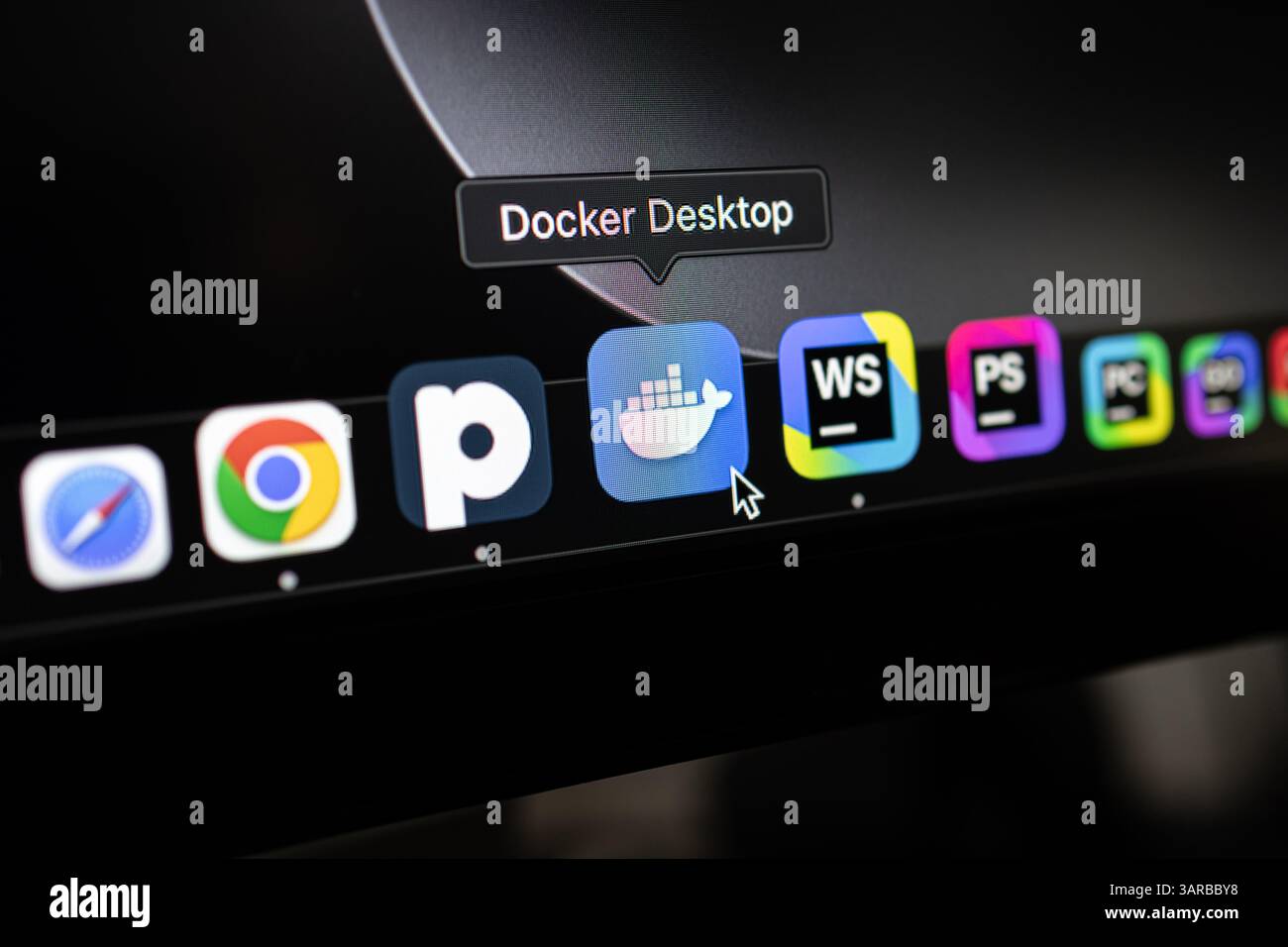 Poznan, Poland – April 14, 2025: close-up of macOS Dock interface with cursor selecting Docker ...