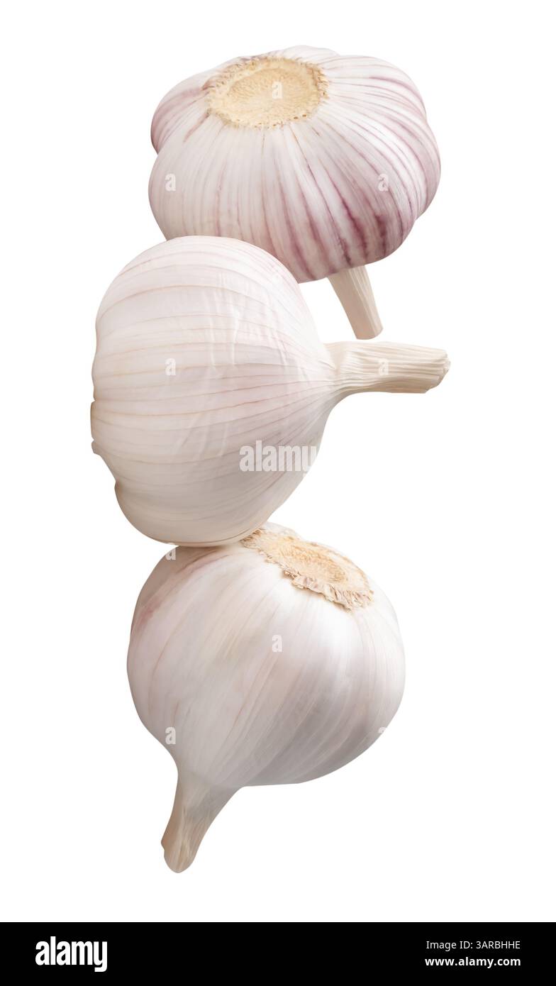 Side view of three white garlic bulbs in stack is isolated on white ...
