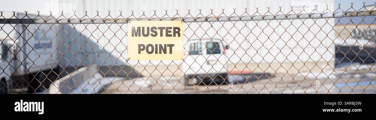 Muster point sign attached to Chain Link Fence Stock Photo - Alamy