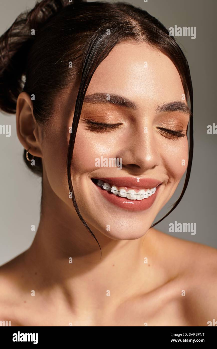 A young beautiful woman exudes happiness and confidence with a radiant ...