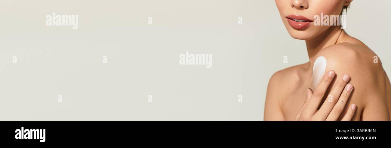 A young woman indulges in self care, applying soothing lotion to her ...