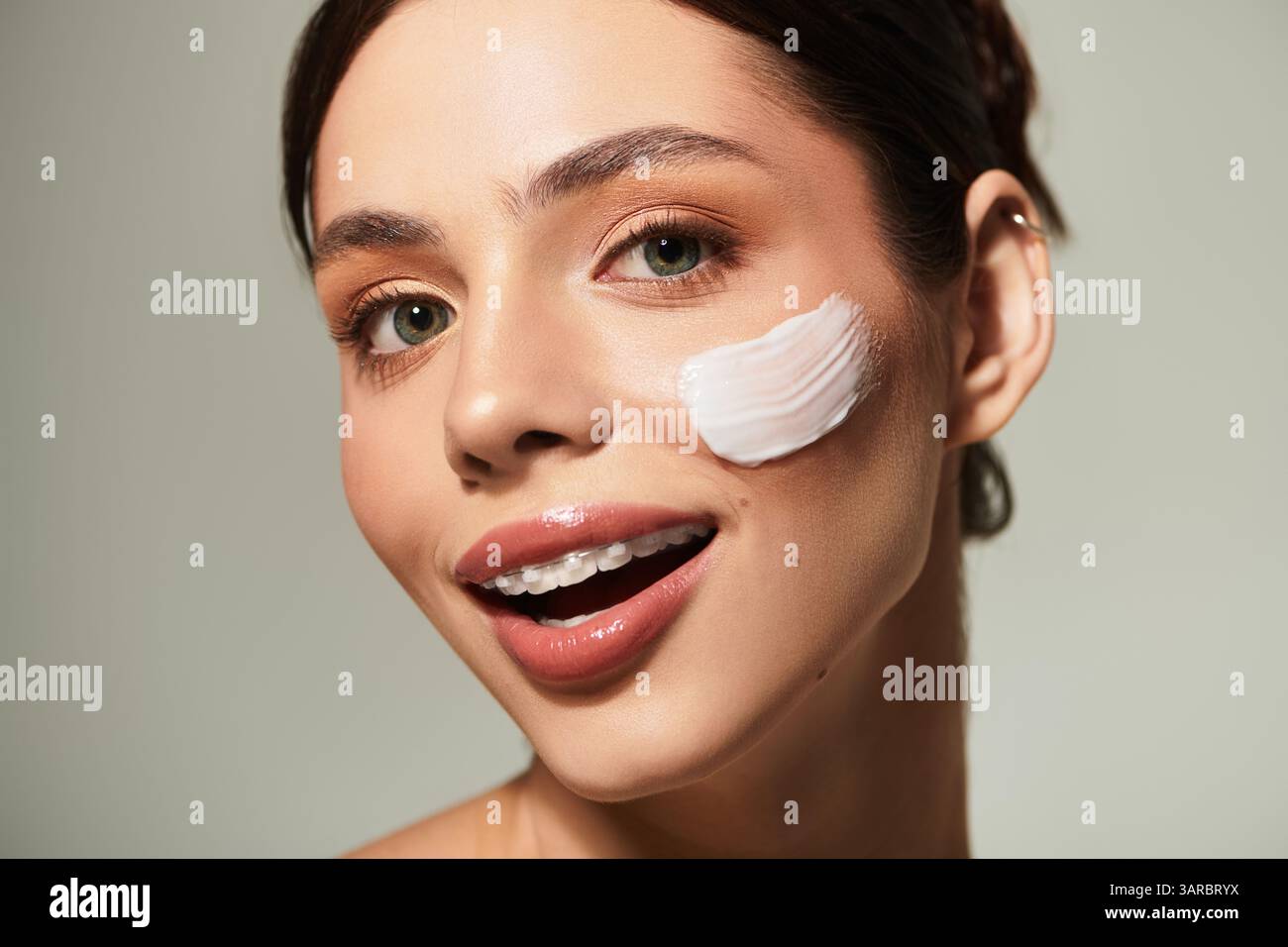 Joyful lady enjoys her skincare routine, enhancing her natural beauty ...