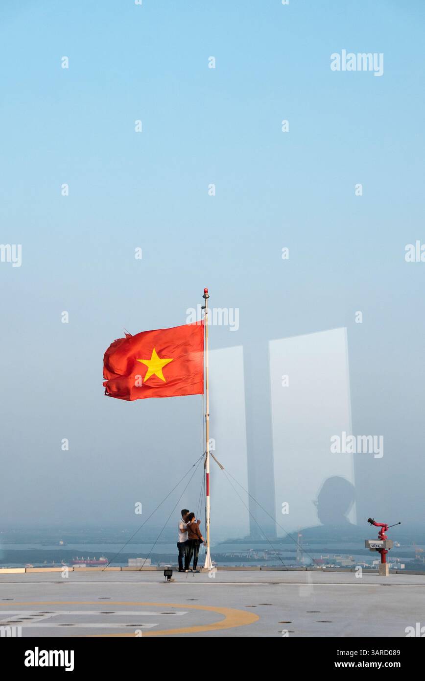 Unrecognizable couple of tourists standing on top of building with ...