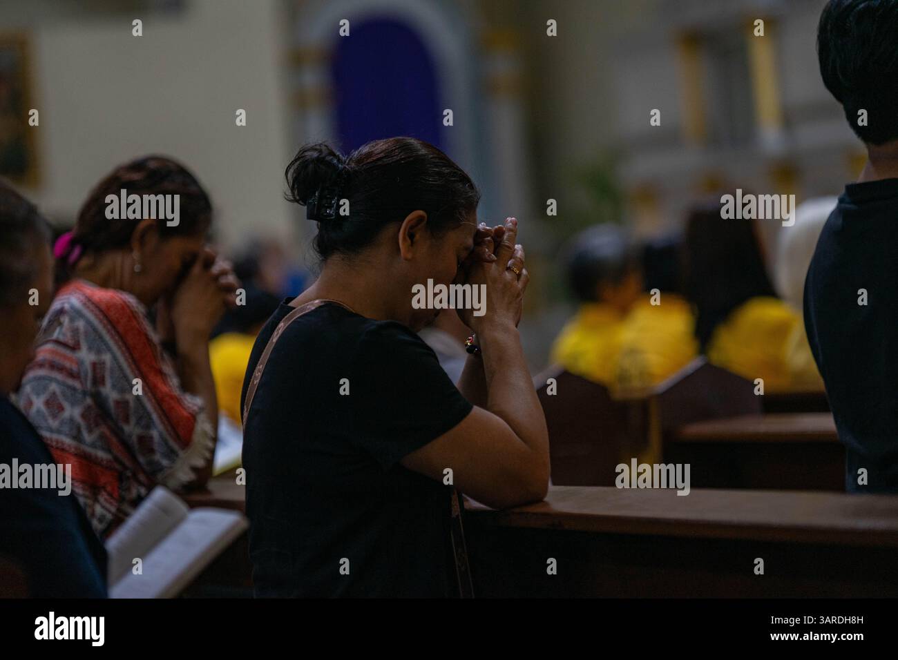 Quezon City, Quezon, Philippines. 17th Apr, 2025. A church goer prays ...