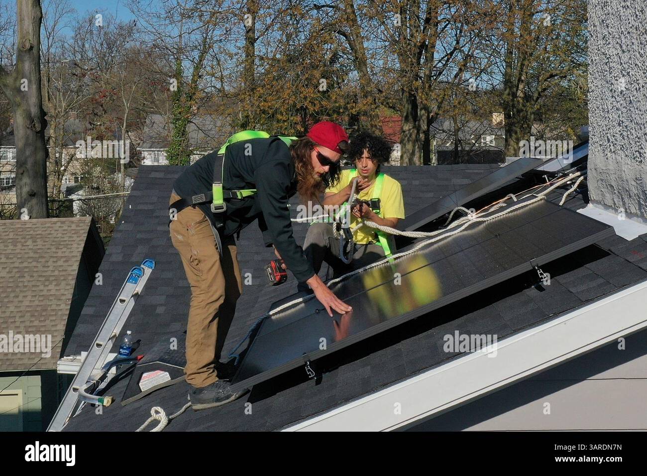 Theodore Tanczuk, left, and Brayan Santos, right, of solar installer ...