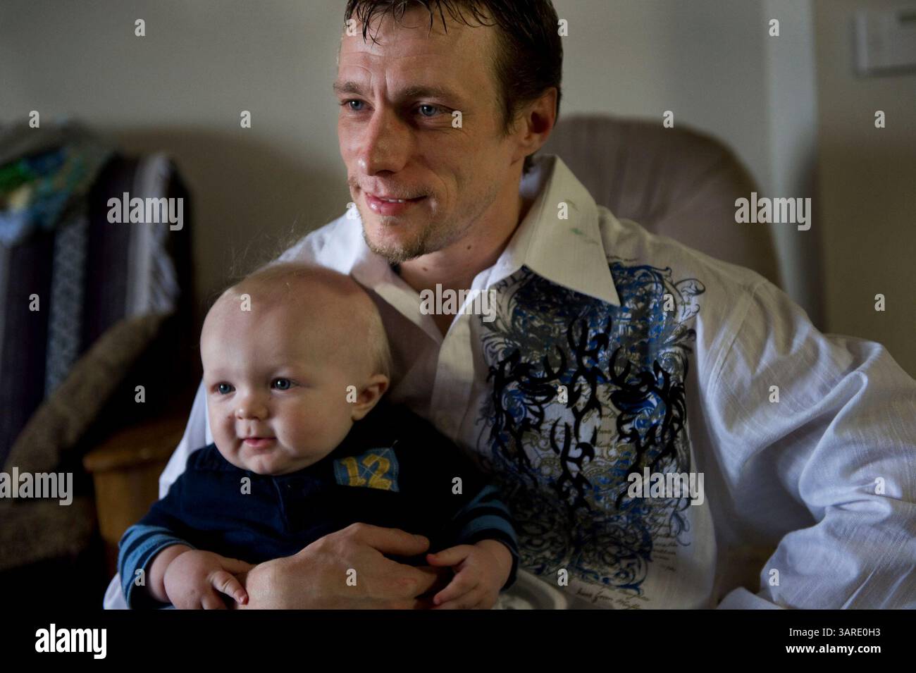 Feb. 04, 2010 - USA - Robert Skeen watches a cartoon with his son ...