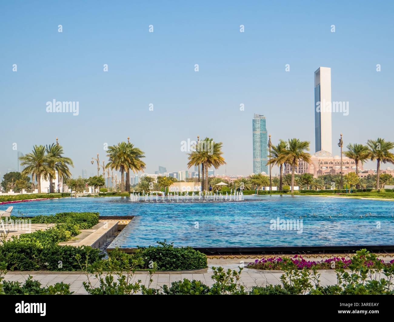 Abu Dhabi with palm trees and skyscrapers. Sunny summer in UAE Stock ...